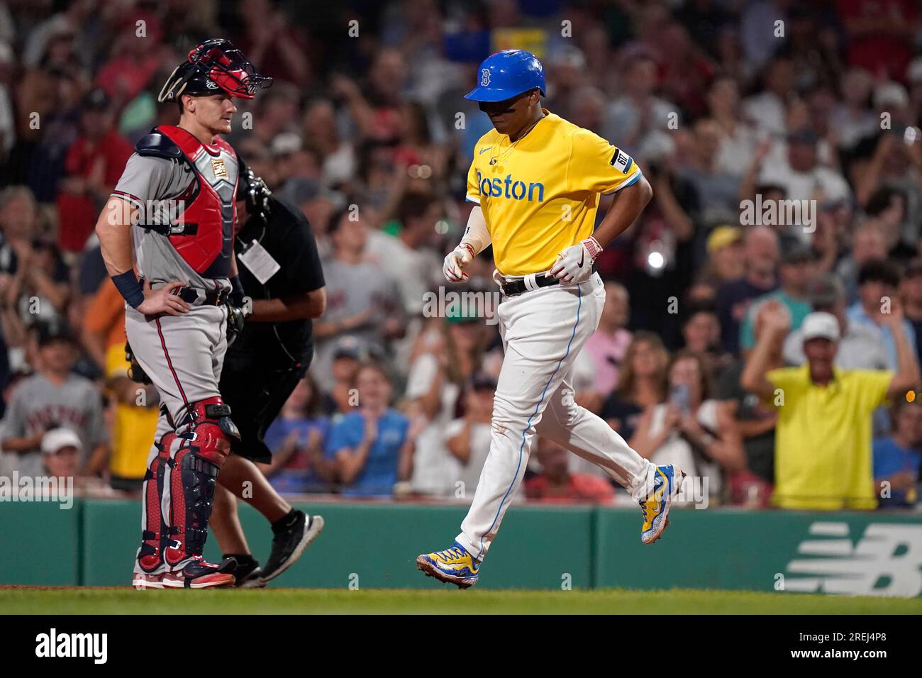 Boston Red Sox's Rafael Devers, right, arrives home to score on his ...