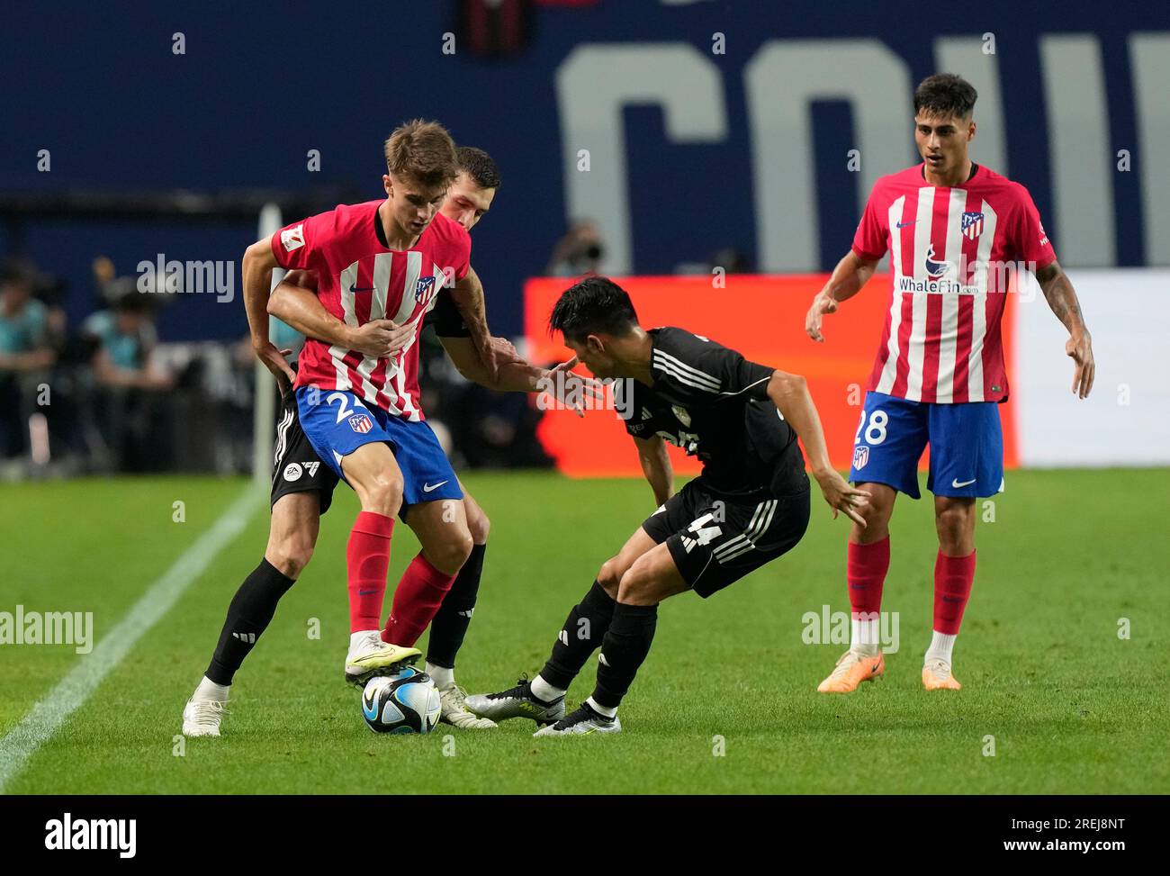 Pablo Barrios, left, of Atletico Madrid fights for the ball against Lee ...
