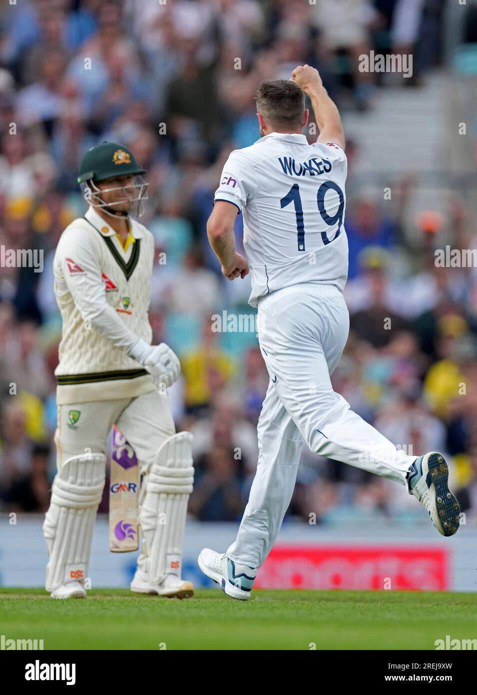 England's Chris Woakes, right, celebrates the dismissal of Australia's ...