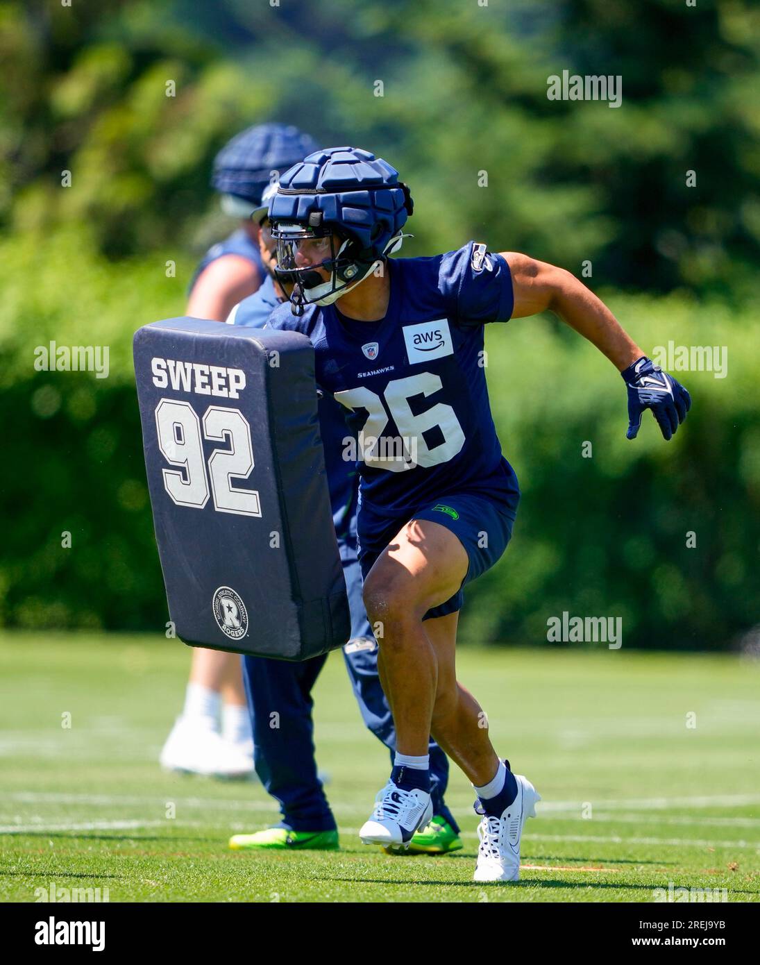 Seattle Seahawks running back Zach Charbonnet (26) runs a drill with a ...