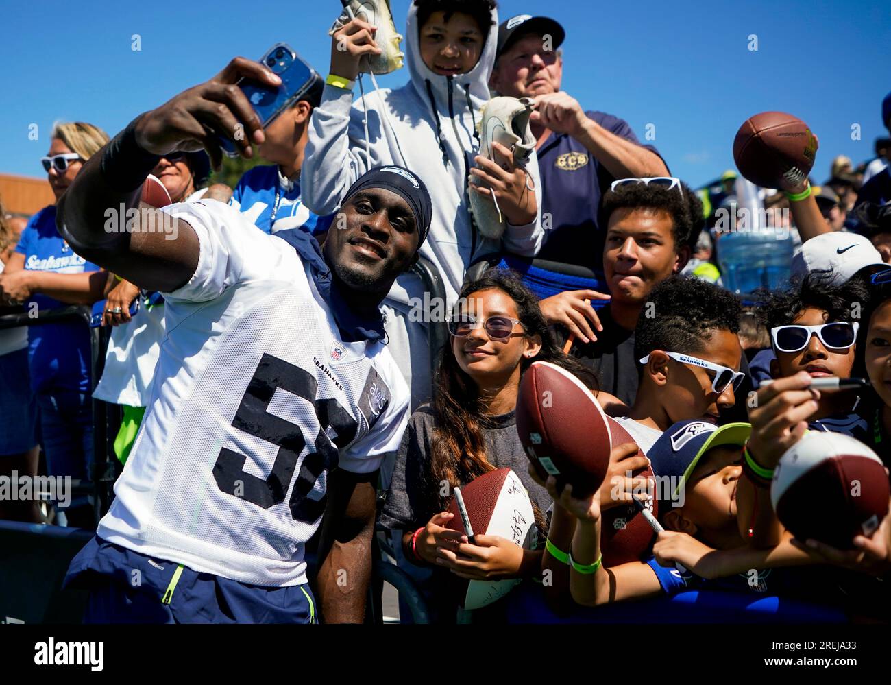Seattle Seahawks linebacker Derick Hall (58) takes a selfie with fans ...
