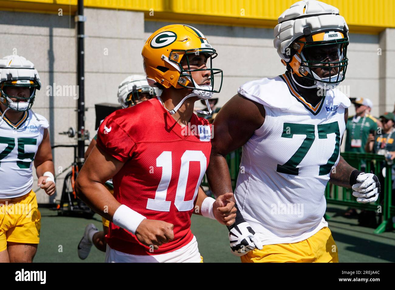 Green Bay Packers' Jordan Love and Kadeem Telfort run on the field ...