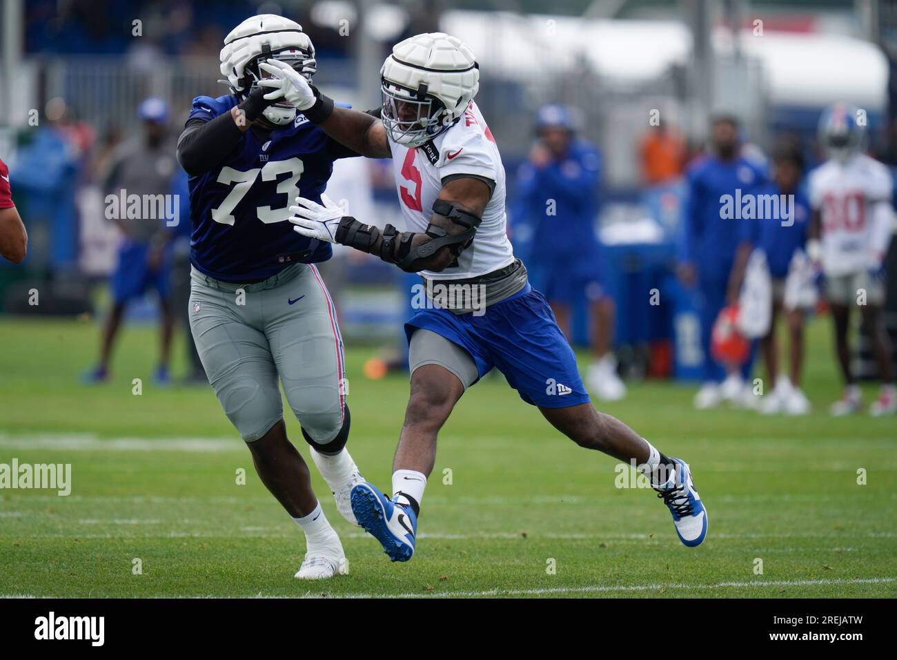 New York Giants' Kayvon Thibodeaux (5), right, competes with Evan Neal ...
