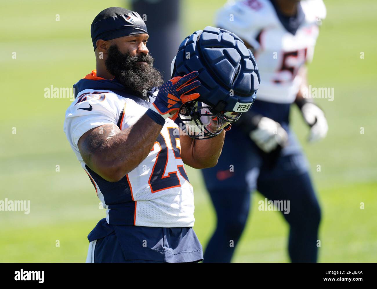 Denver Broncos running back Samaje Perine puts on his helmet as he ...