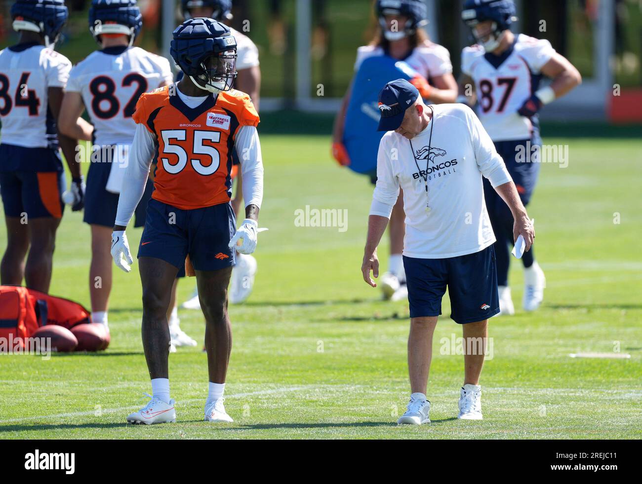 Denver Broncos linebacker Frank Clark, left, jokes with head coach Sean ...