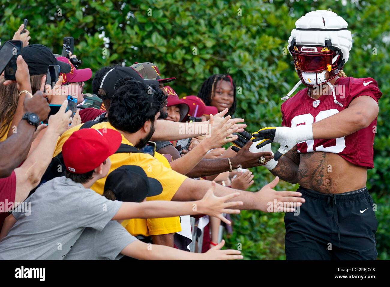 Washington Commanders defensive end Chase Young (99) greets fans as he ...