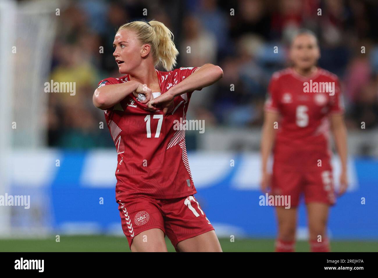Denmark's Rikke Marie Madsen tucks a sheet of paper back into her shirt ...