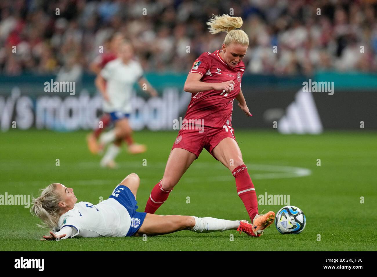 England's Alex Greenwood, left, tackles Denmark's Rikke Marie Madsen ...