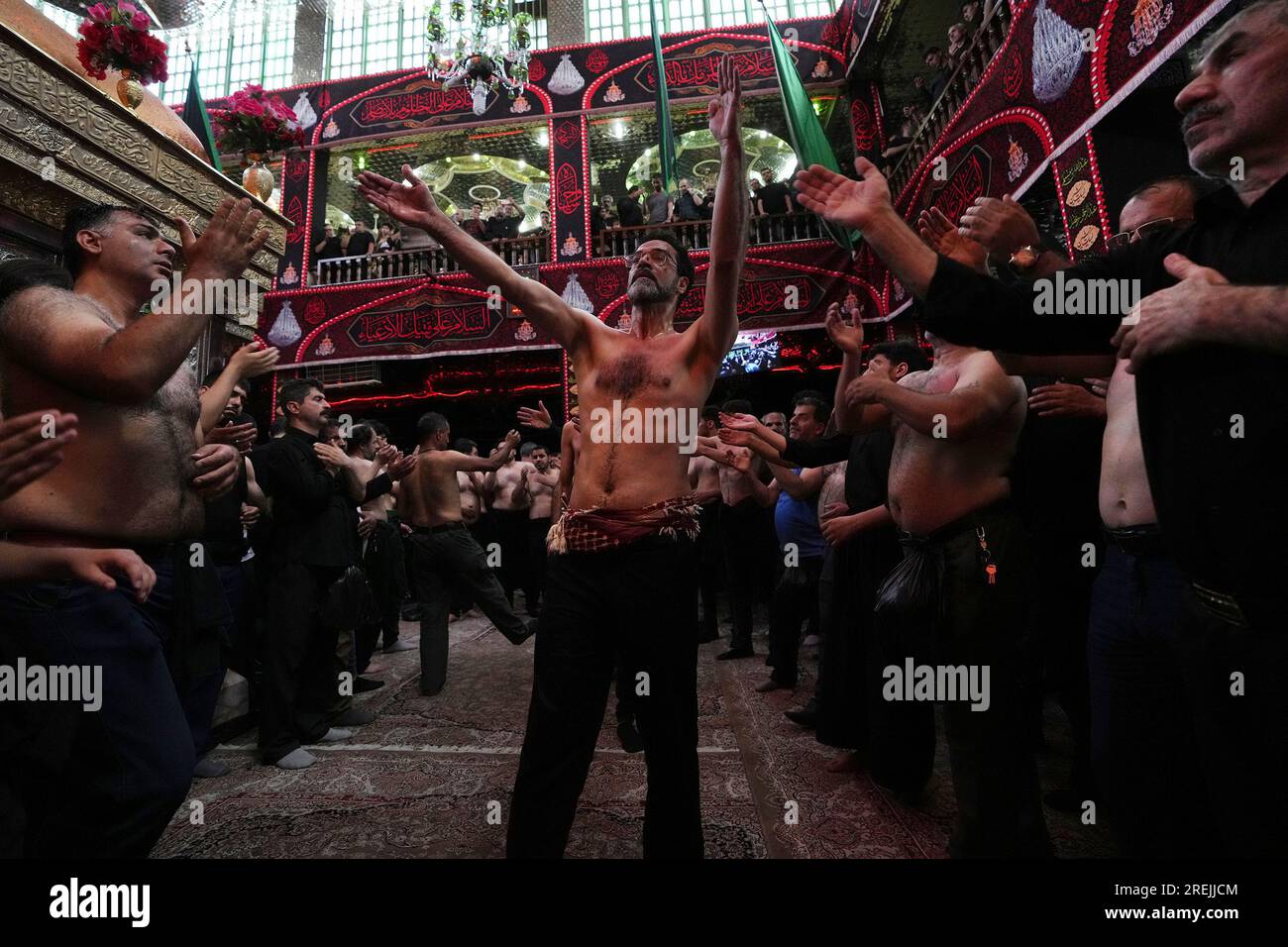Iranian and Iraqi Shiite Muslims beat their heads and chests during the ...