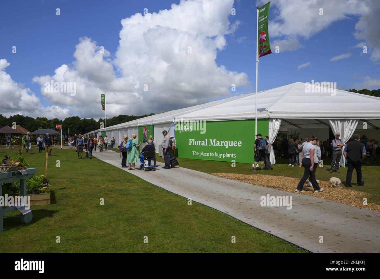 Visitors passing exterior of giant marquee (people making their way ...