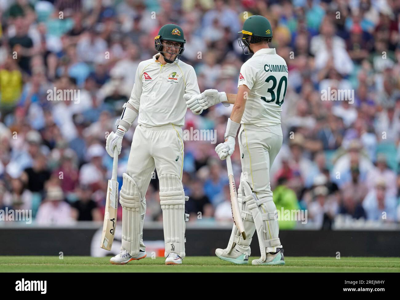 Australia's Todd Murphy, left, celebrates with captain Pat Cummins ...