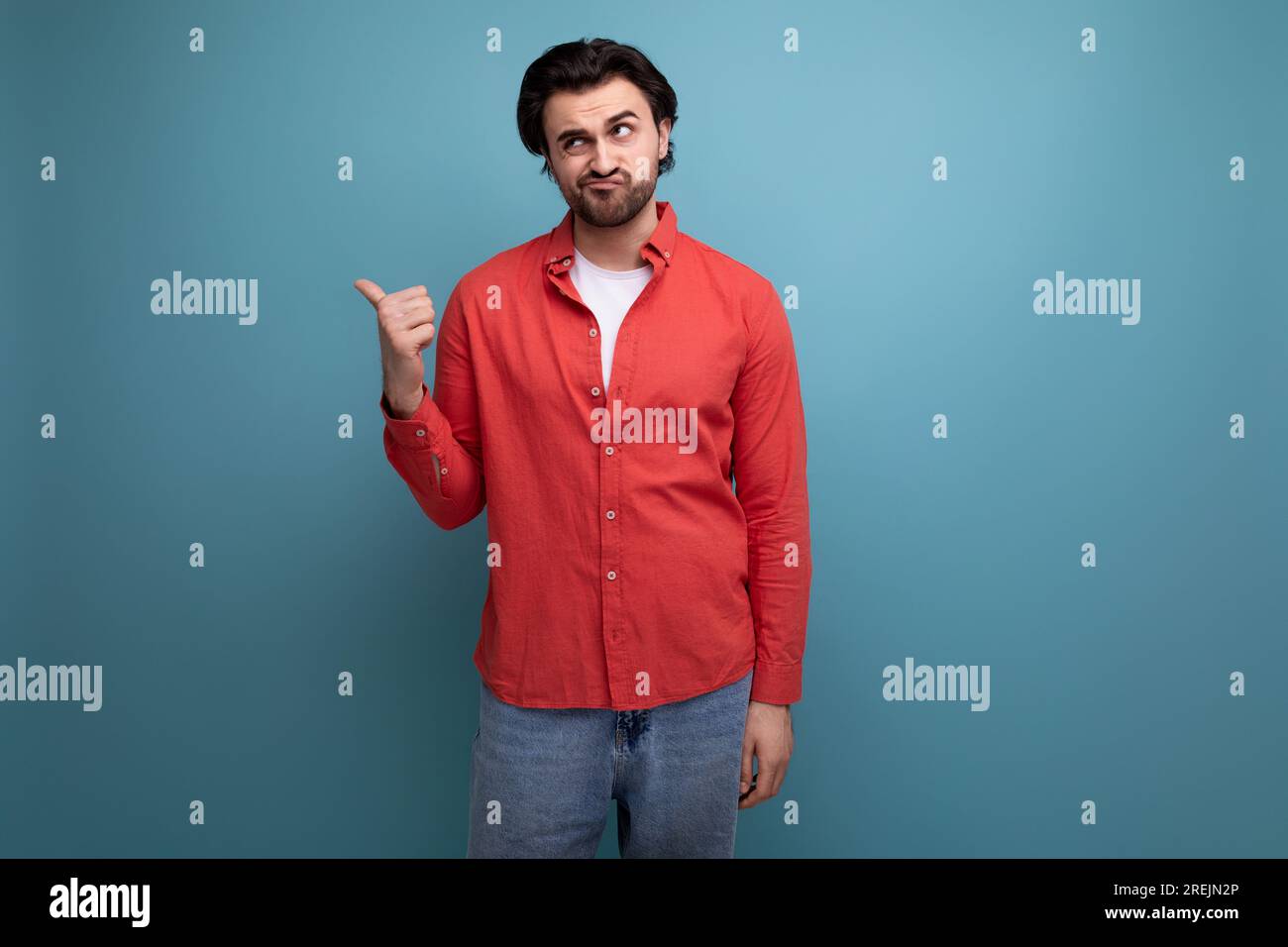 young european handsome guy with a stylish hairstyle shows his hand to ...