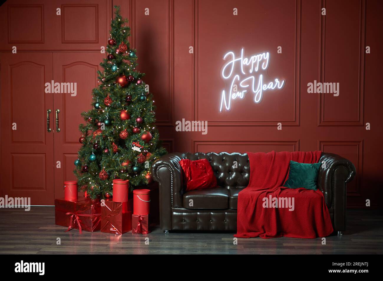 Red Christmas interior in the living room with sofa and plaid Stock ...