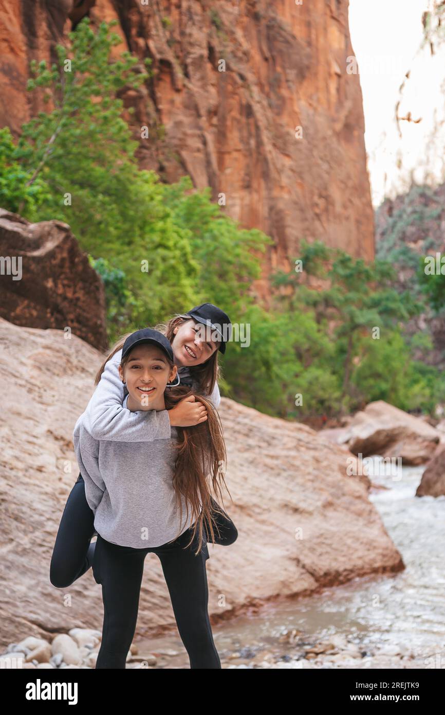 Two girls hiking in the mountains. Teenage girls having fun and walking ...