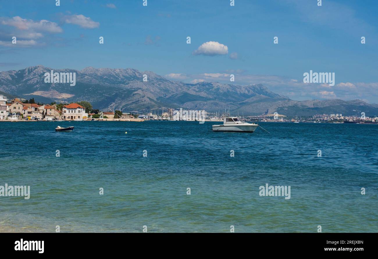 The coast of Kastel Gomilica in Kastela, Croatia. Split is far right ...