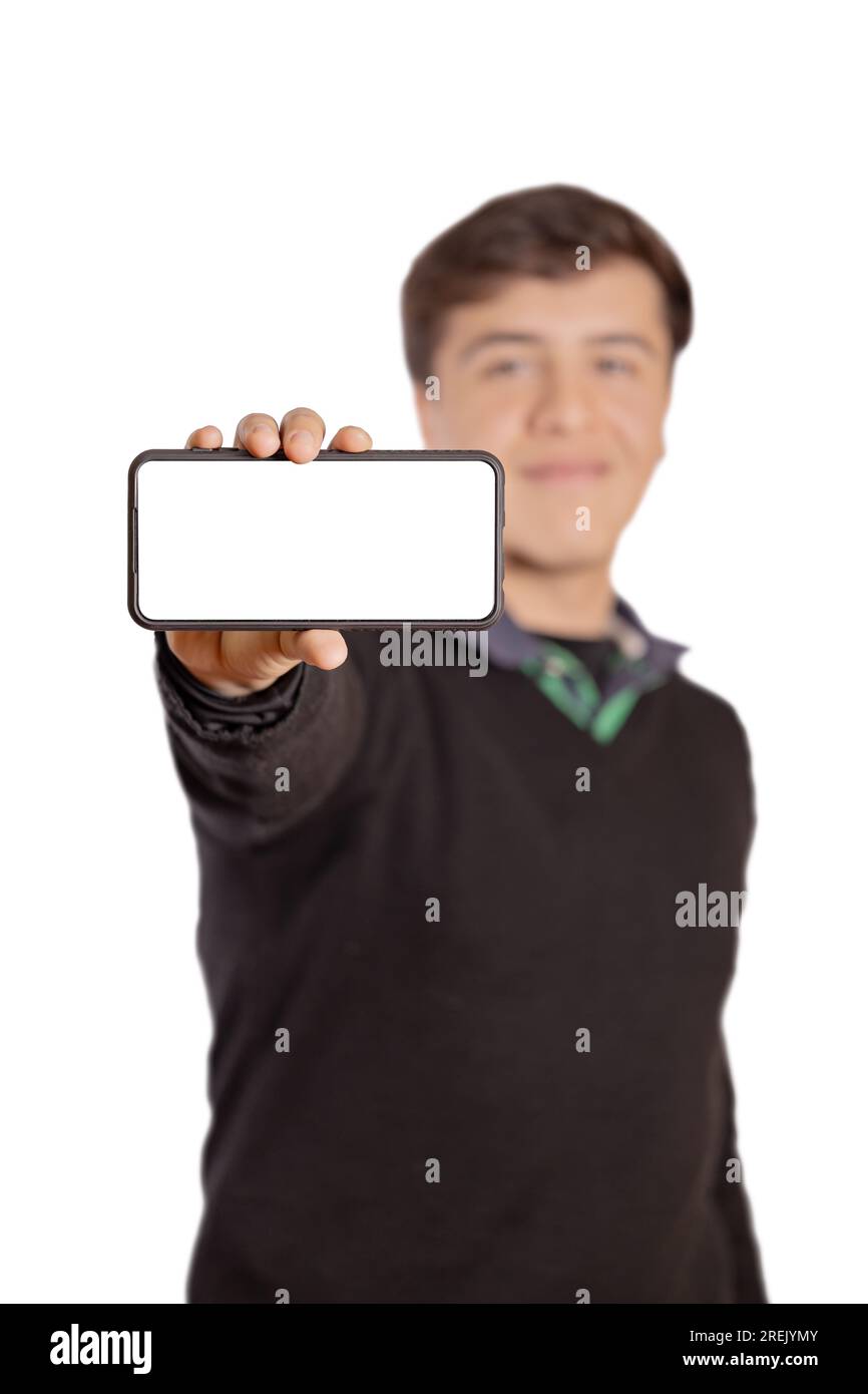 Portrait of a defocused boy showing the screen of his mobile phone ...