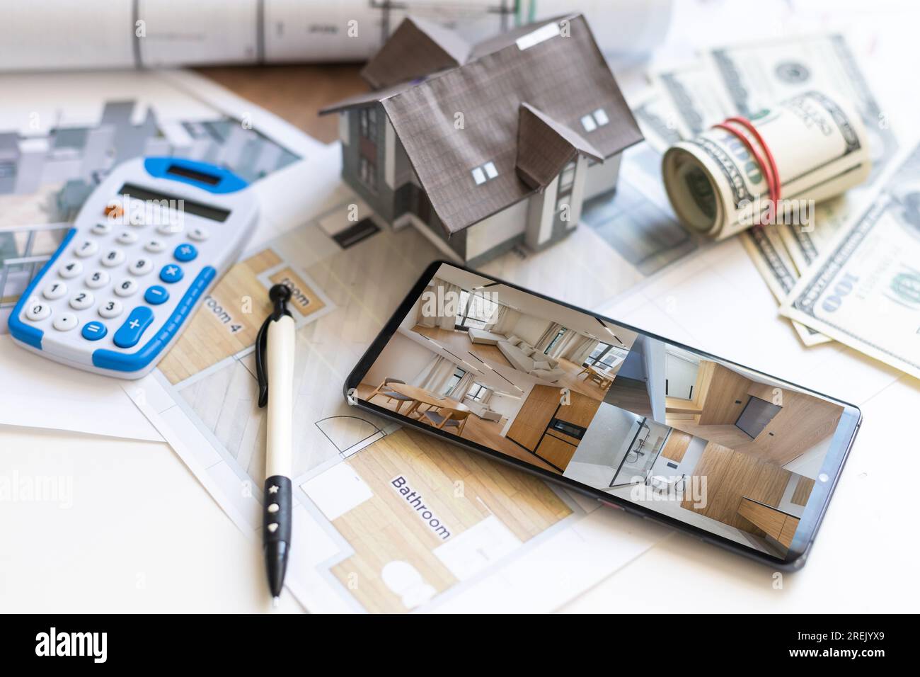 Blueprints, house model, notebook and pen on the table - architecture ...