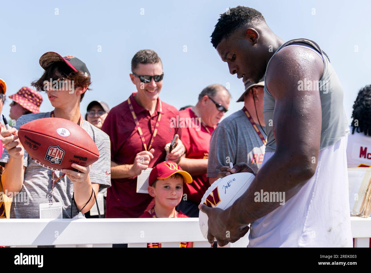 Washington Commanders safety Percy Butler signs a young fan's football ...