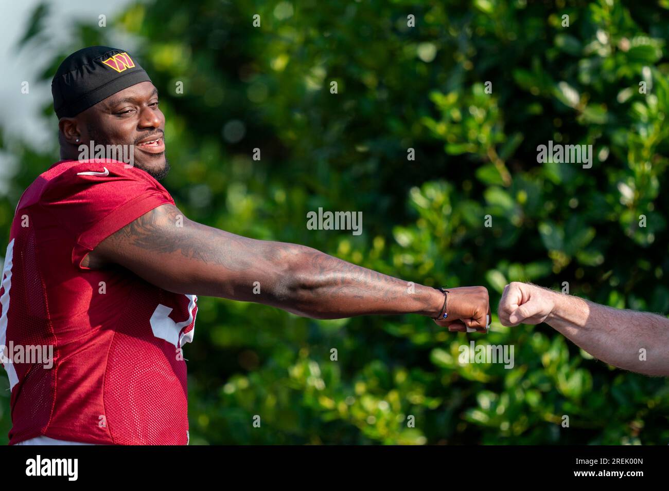 Washington Commanders defensive end Efe Obada fist bumps a fan while ...