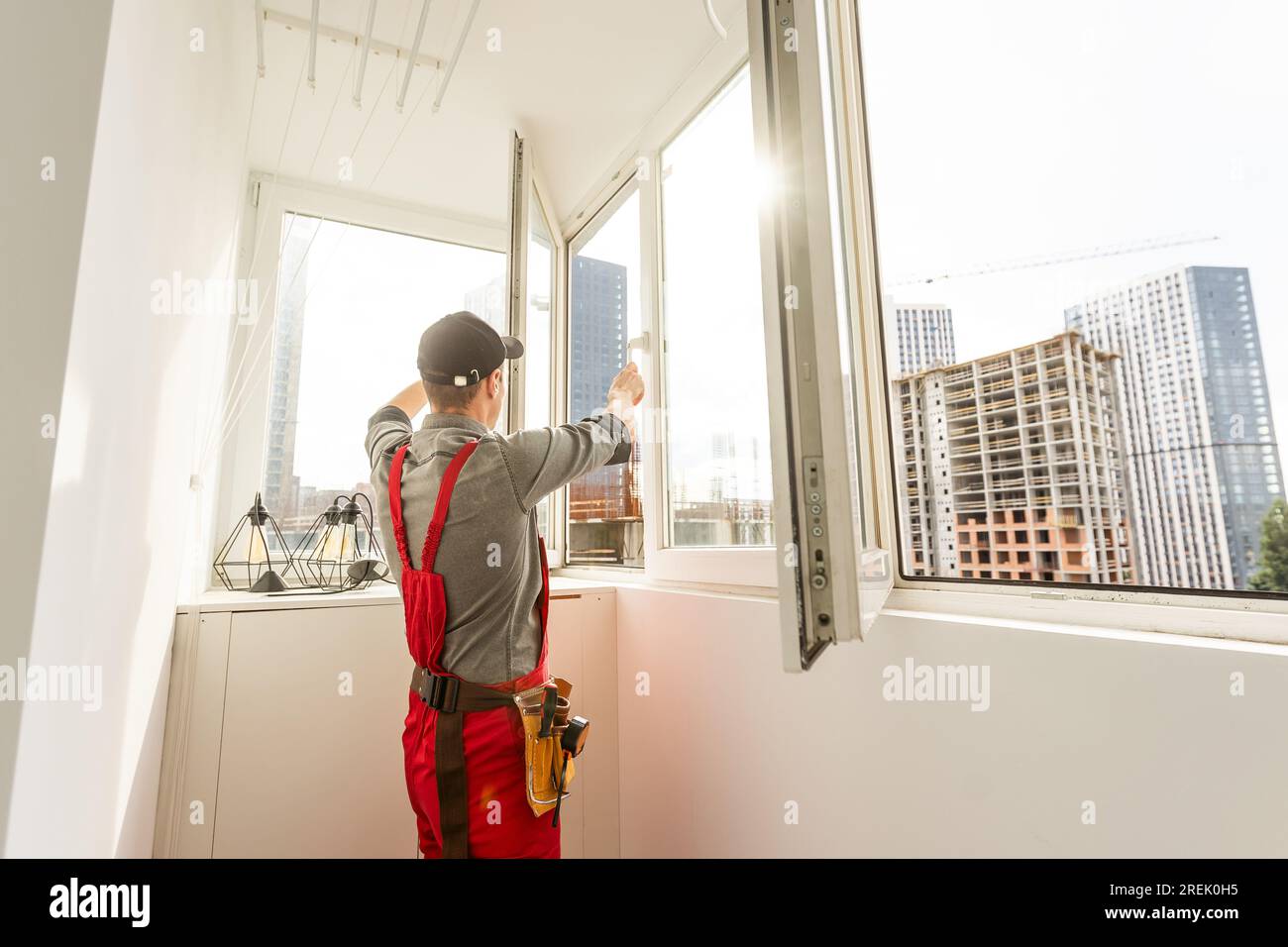 Construction worker using drill while installing window indoors Stock ...