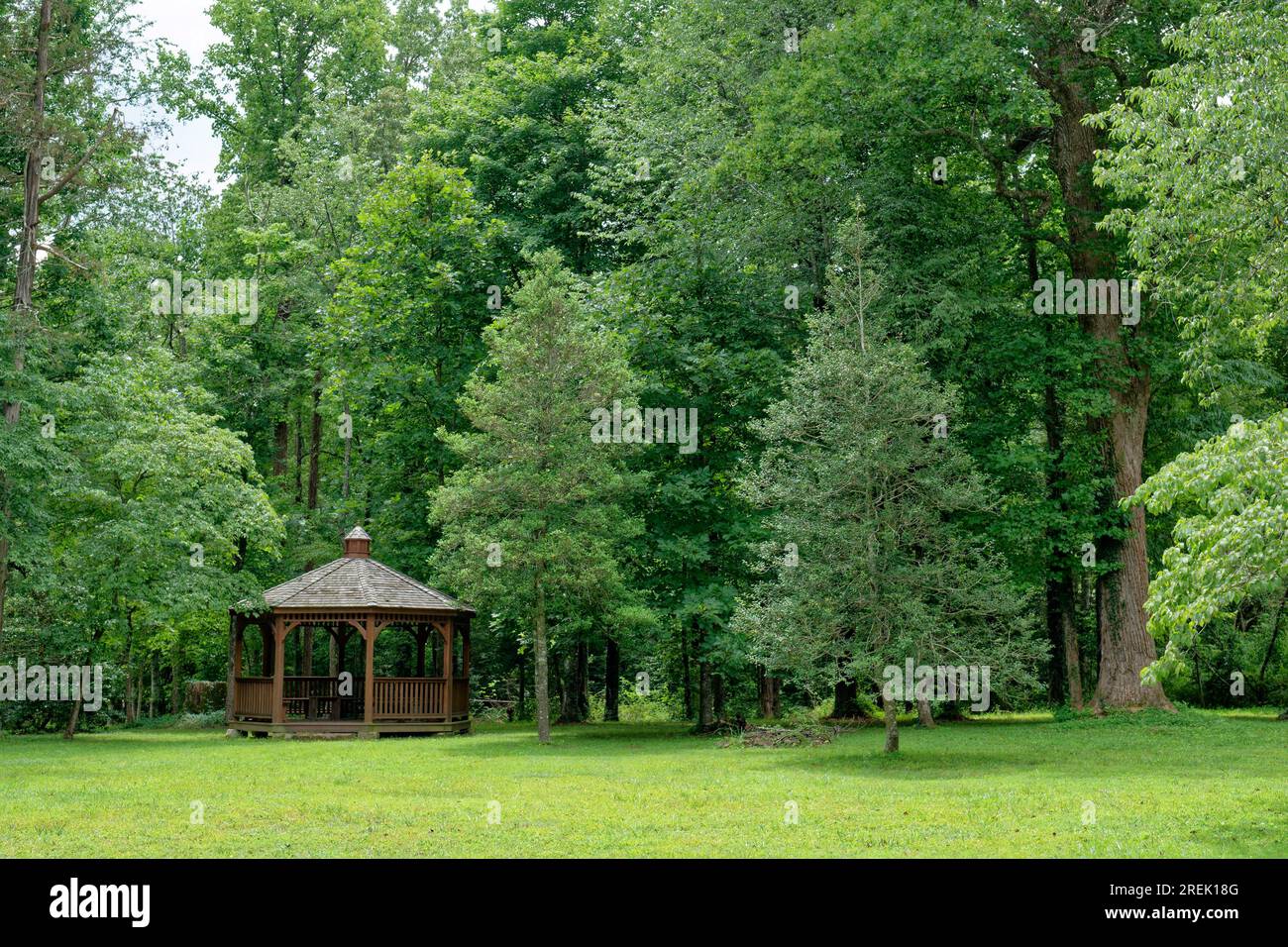 Small park with a large gazebo with benches inside surrounded by a ...