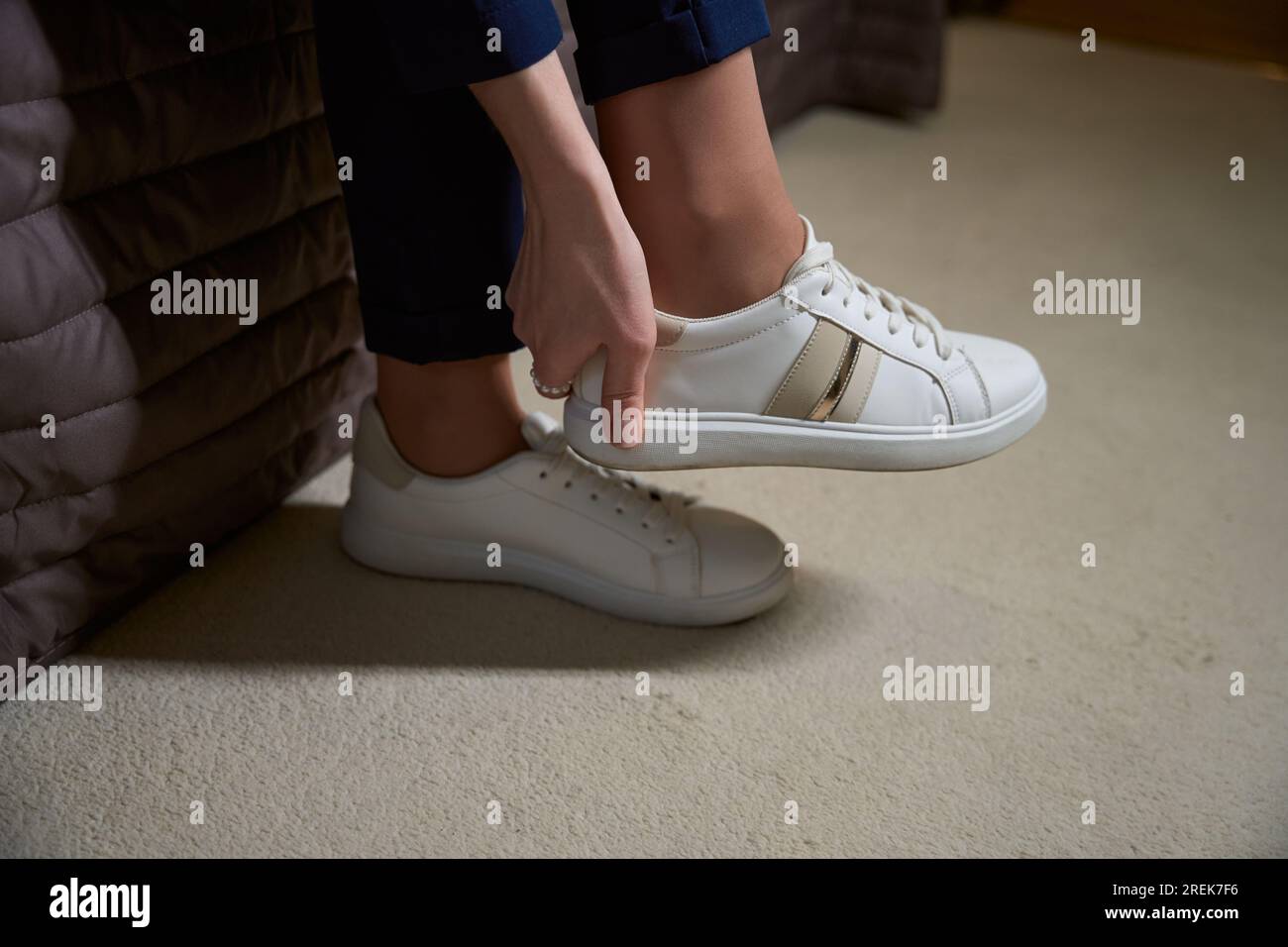 Woman taking off shoes in the motel Stock Photo - Alamy