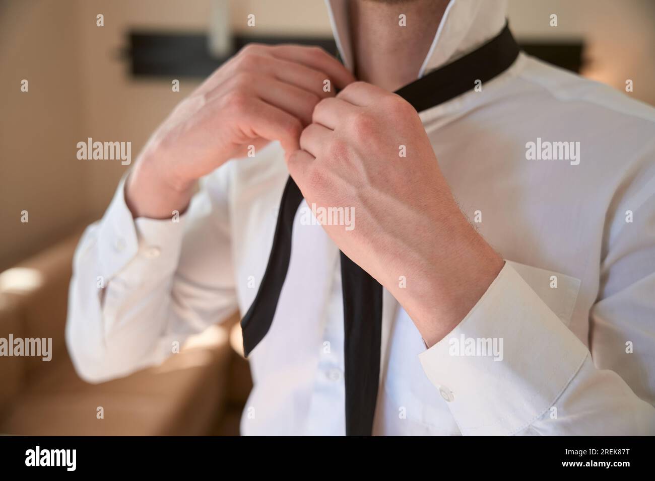 Man getting dressed before job in the hotel Stock Photo - Alamy