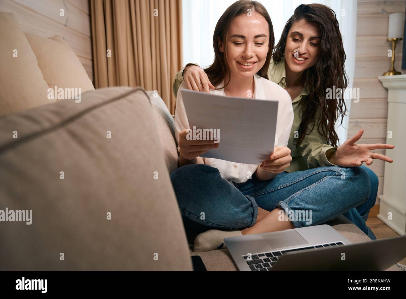 Pretty smiling women doing paperwork or studying Stock Photo - Alamy