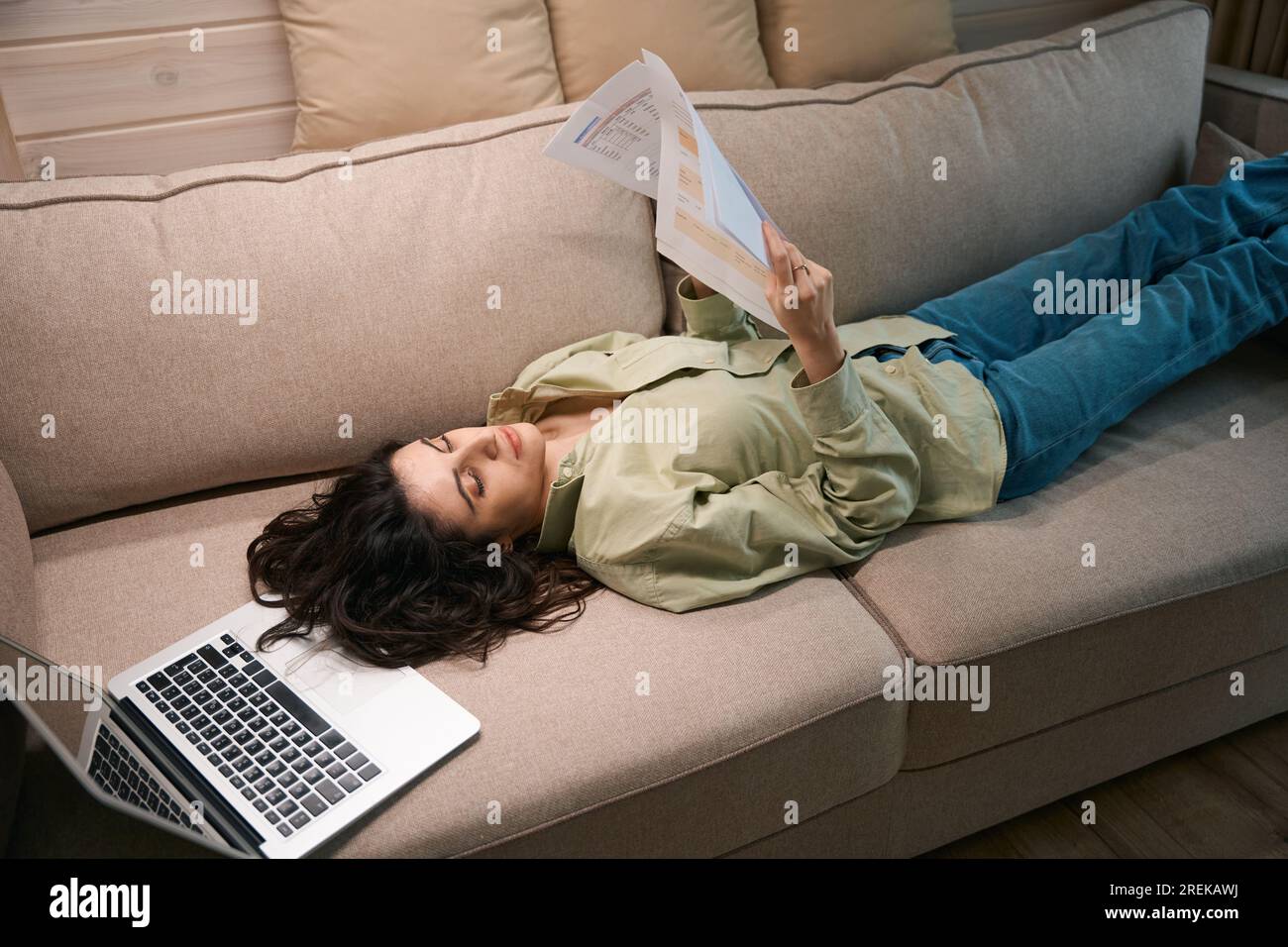 Concentrated young lady doing paperwork or studying Stock Photo - Alamy