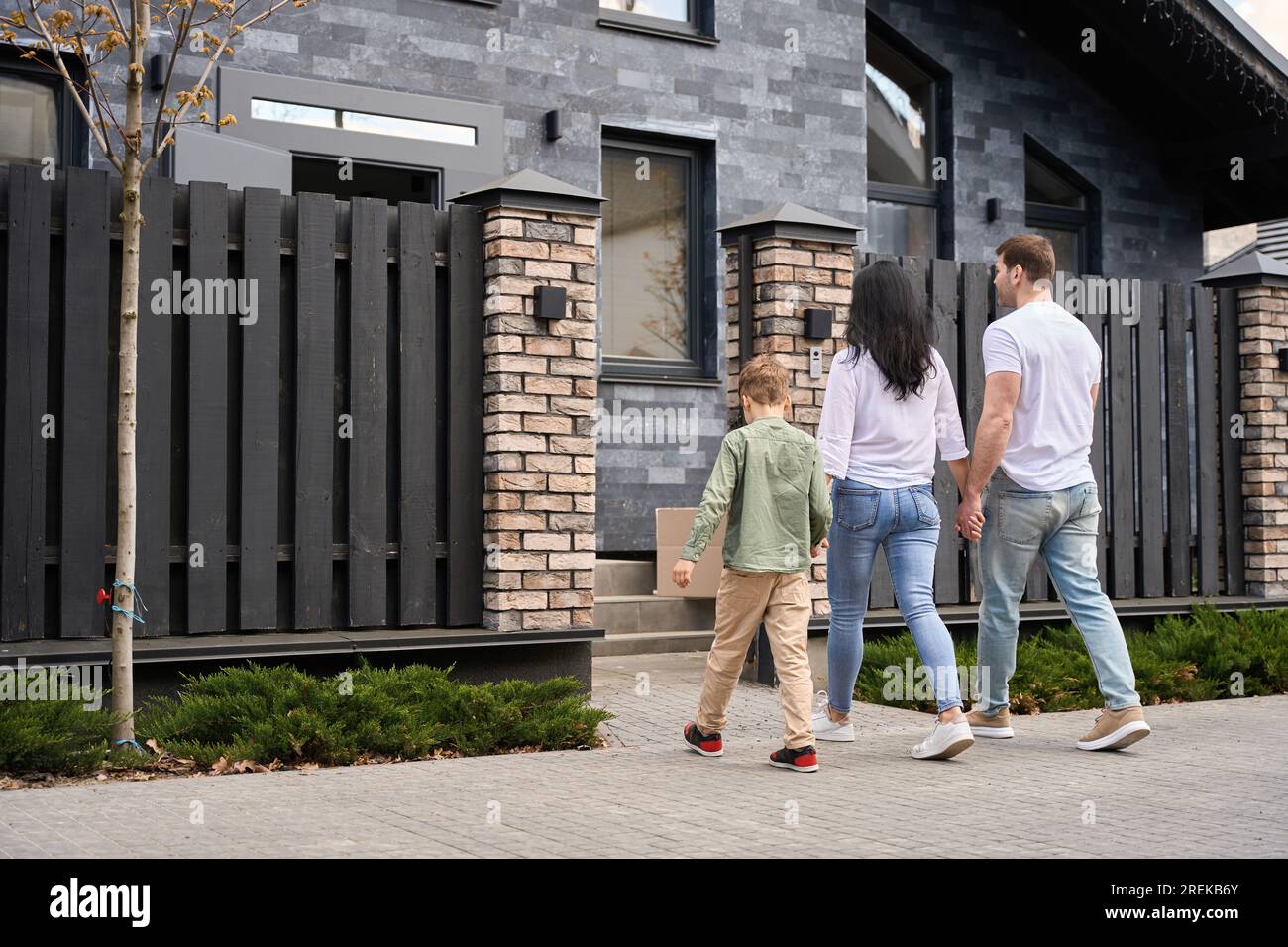 Family enters the house through the gate Stock Photo - Alamy