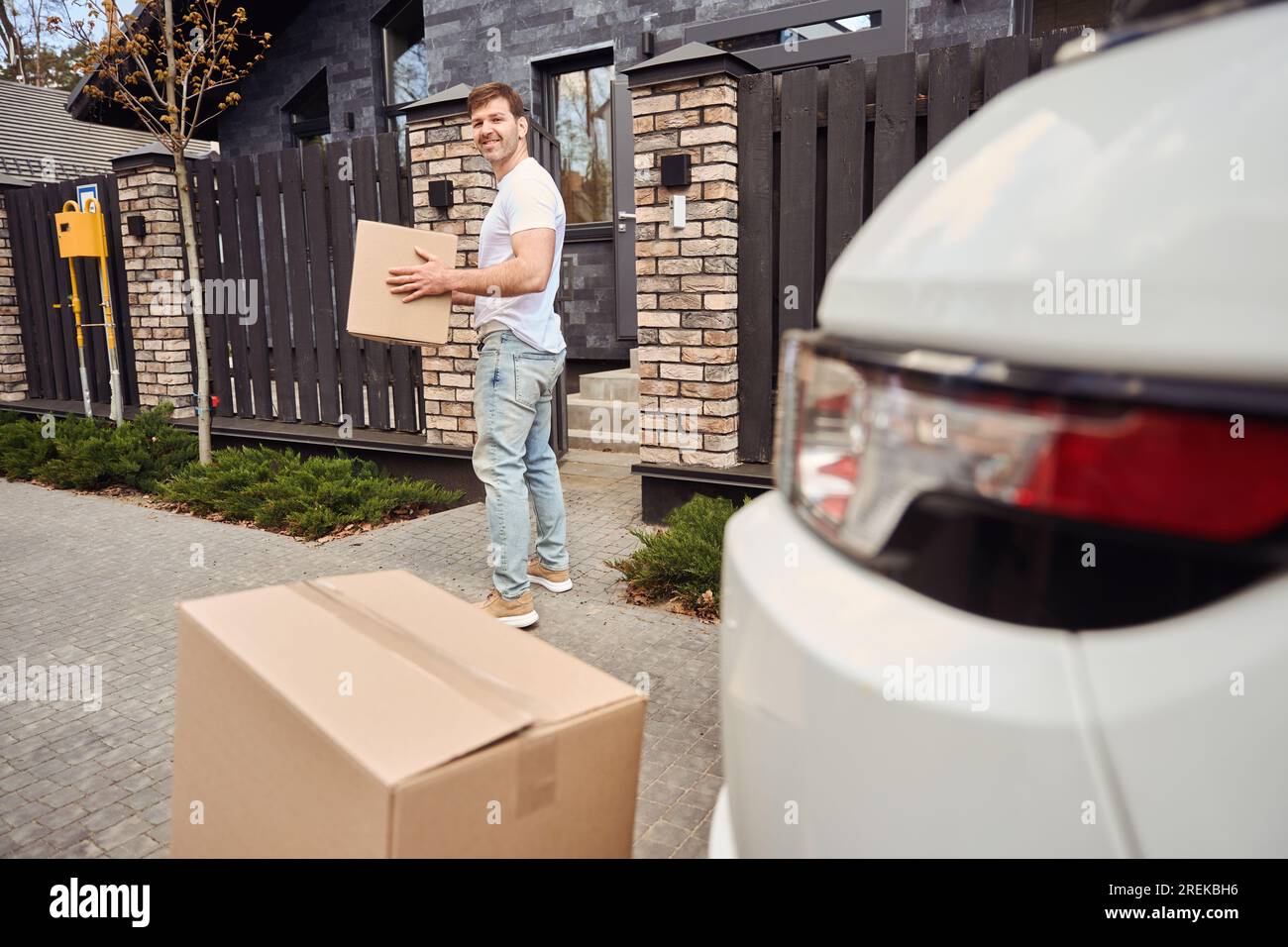 Couple smile walking carrying box hi-res stock photography and images ...