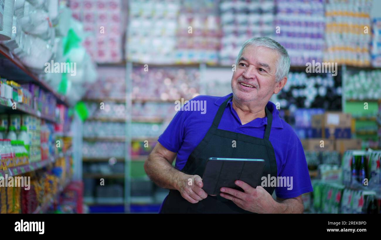 Joyful Senior Grocery Store Manager Checking Product Inventory on Shelf ...
