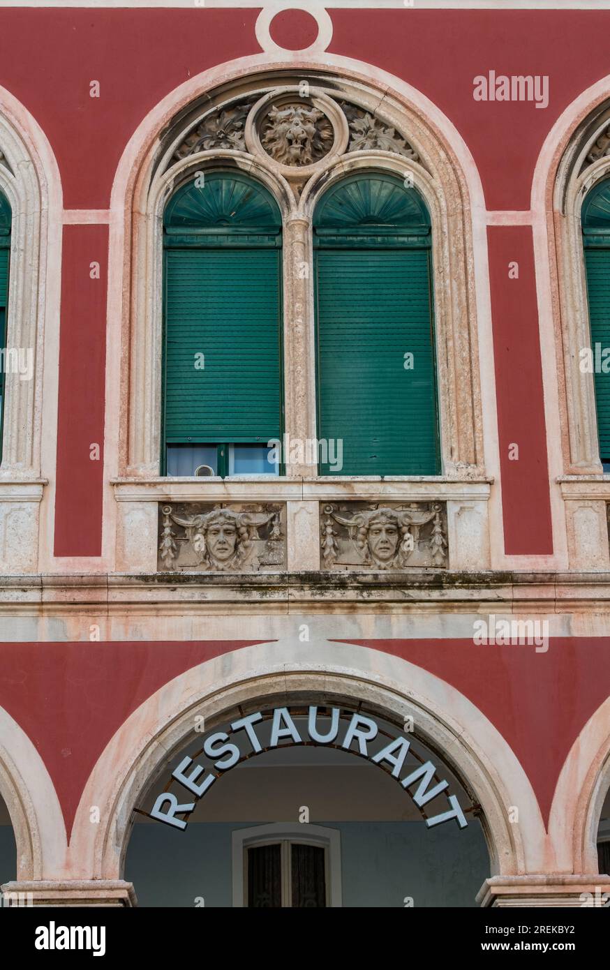 ornate colourful shuttered window above a restaurant sign in grad split ...