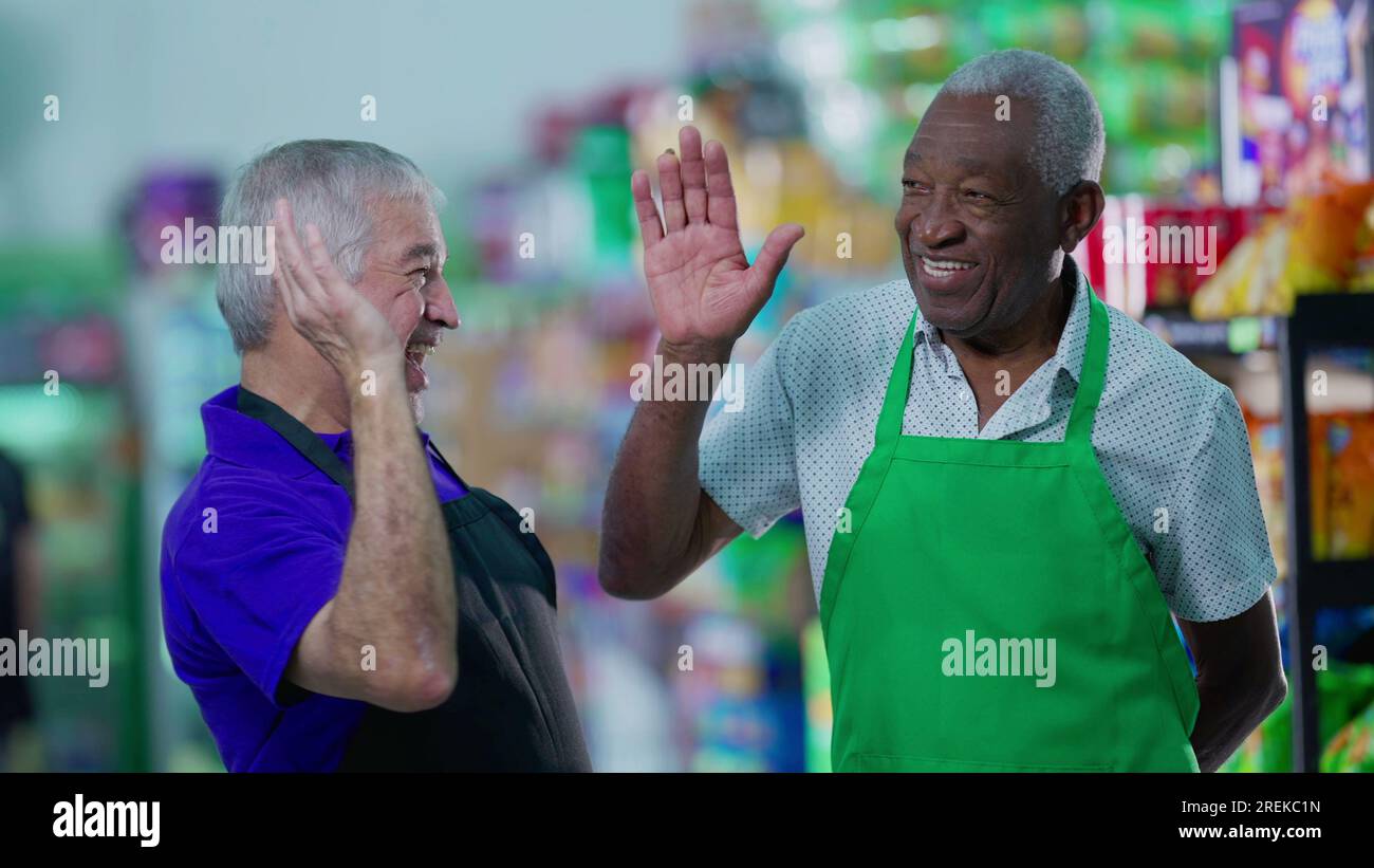 Happy diverse senior employees celebrating success with high-five ...