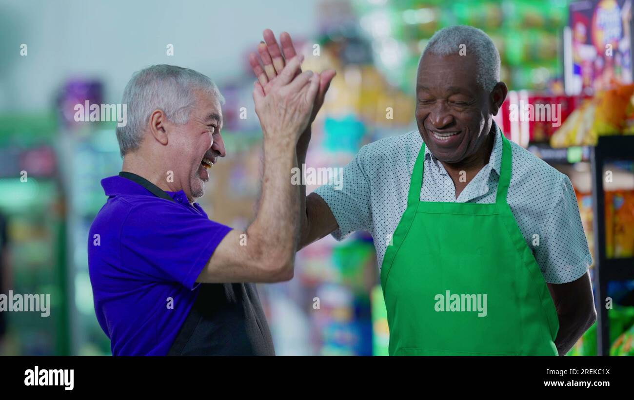 Happy diverse senior employees celebrating success with high-five ...