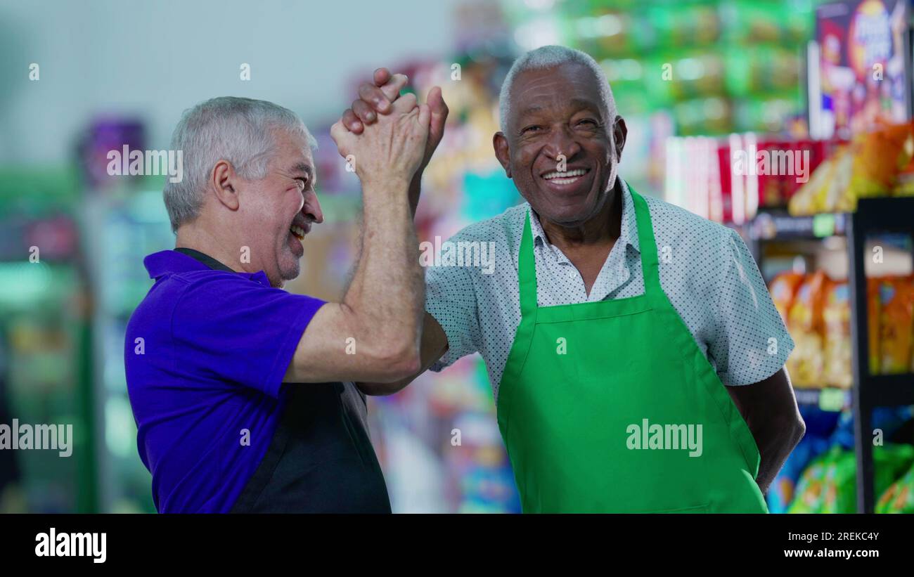 Happy diverse senior employees celebrating success with high-five ...
