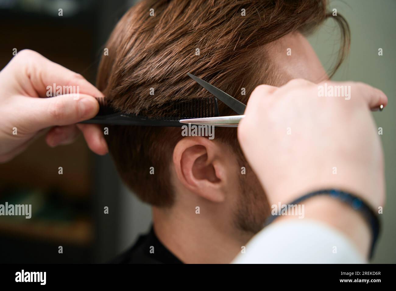 Barber making haircut to his client in room Stock Photo - Alamy