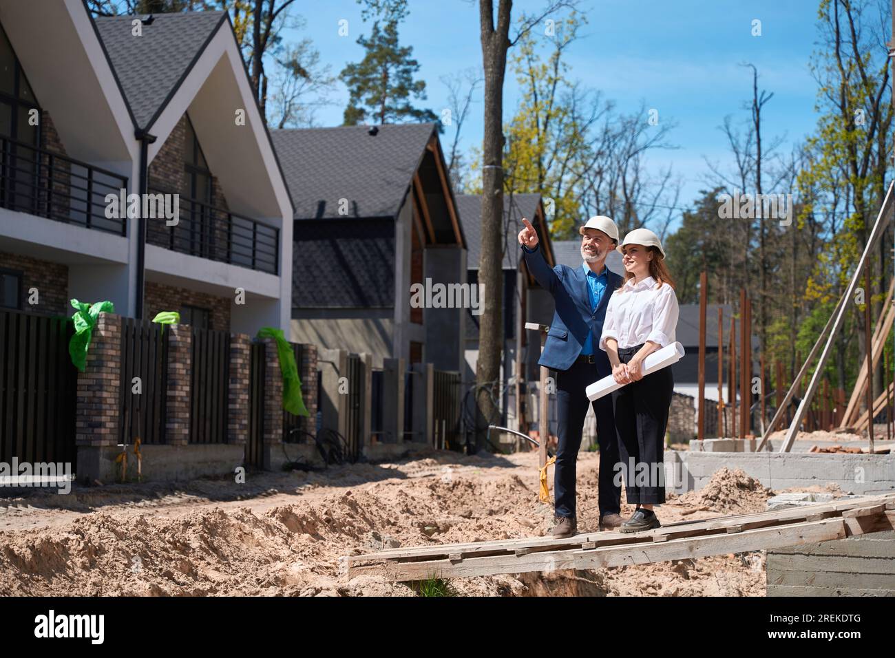Man house developer asking questions to woman head architect about construction Stock Photo - Alamy
