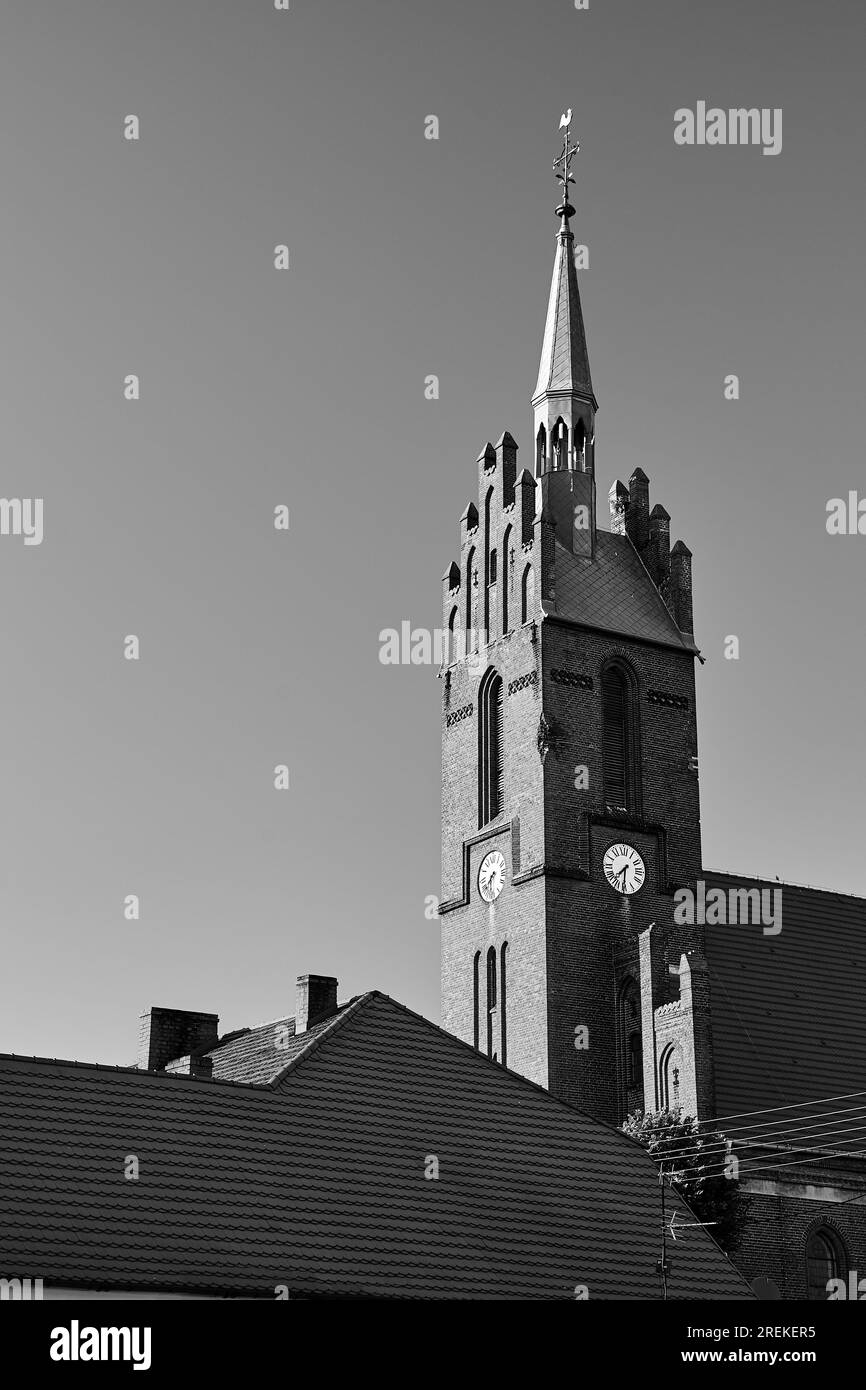 The historic tower of the Gothic red brick church in the village of ...