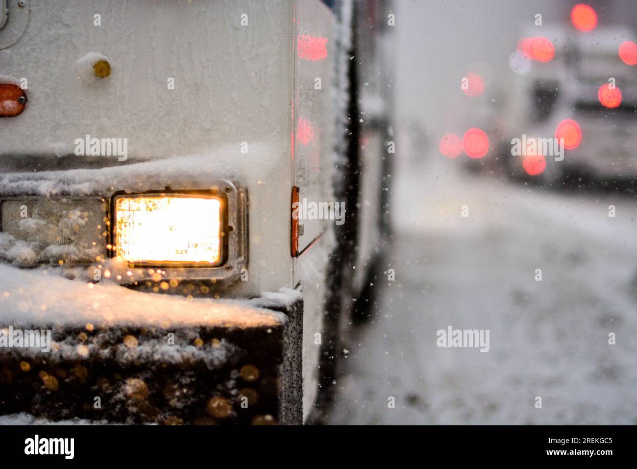 City bus close up of snow covered street, snow storm public transport ...