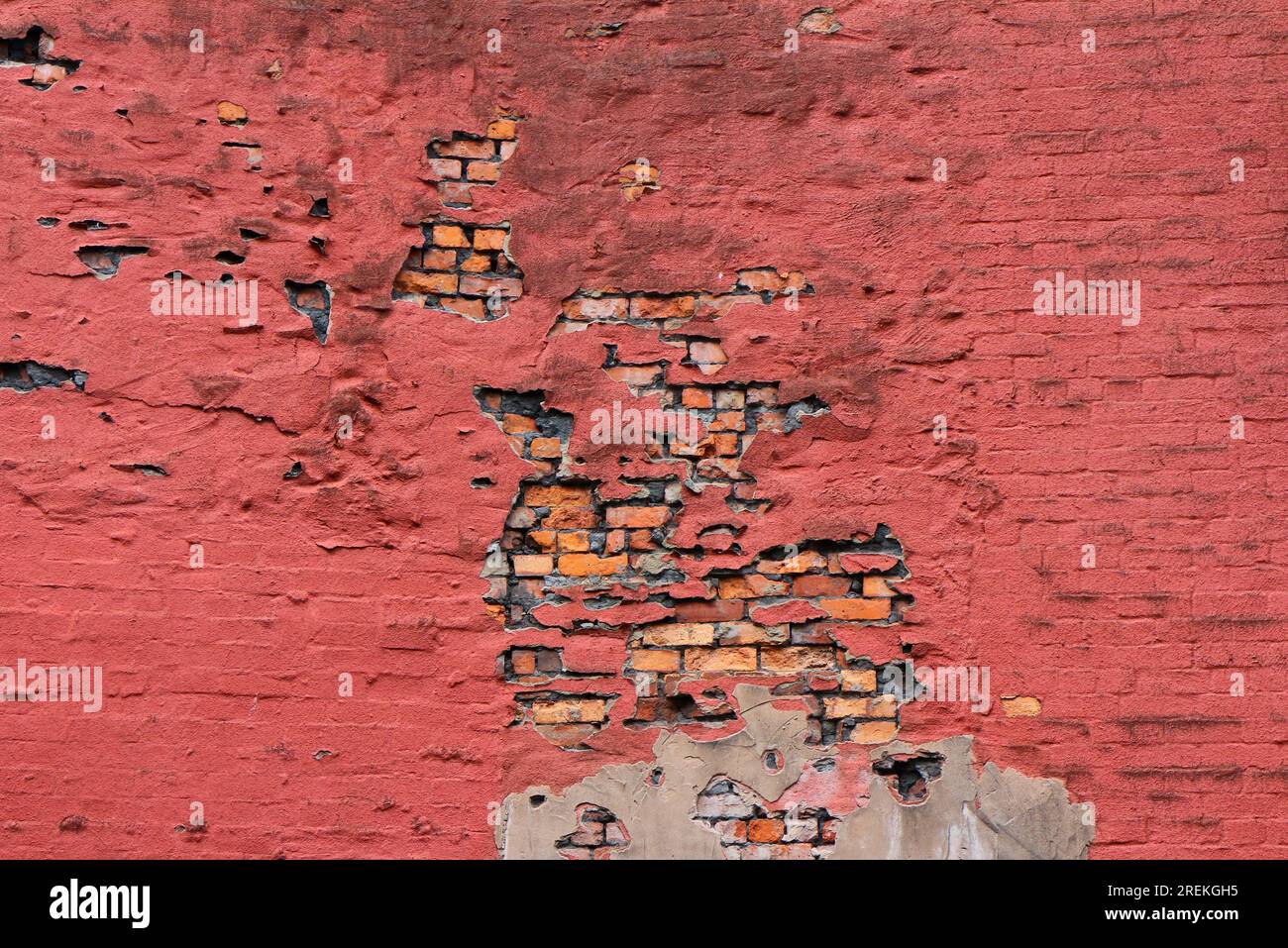 Paint and plaster flaking from a brick building in Glossop, England ...