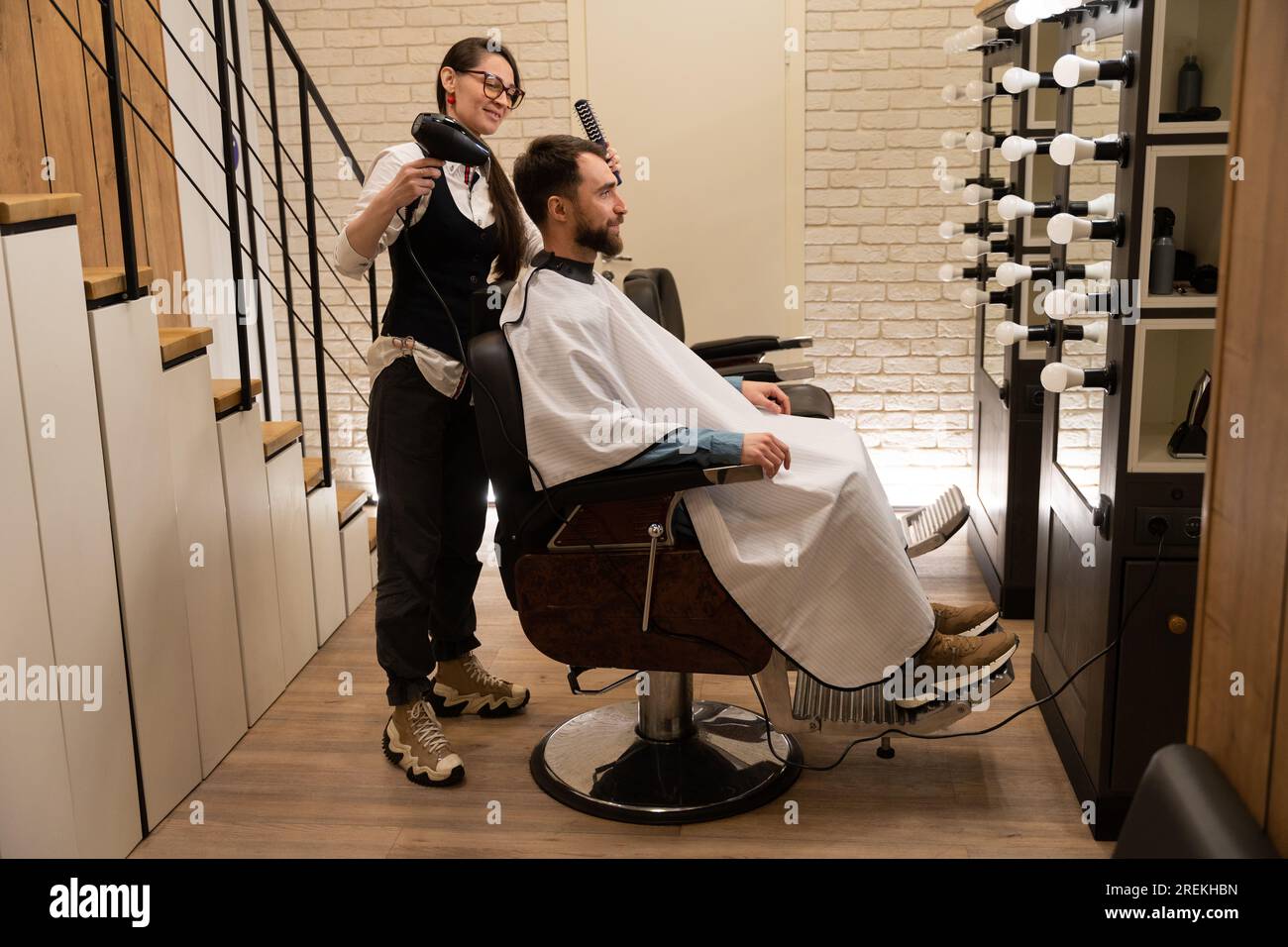 Barber uses hair dryer style hi-res stock photography and images - Alamy