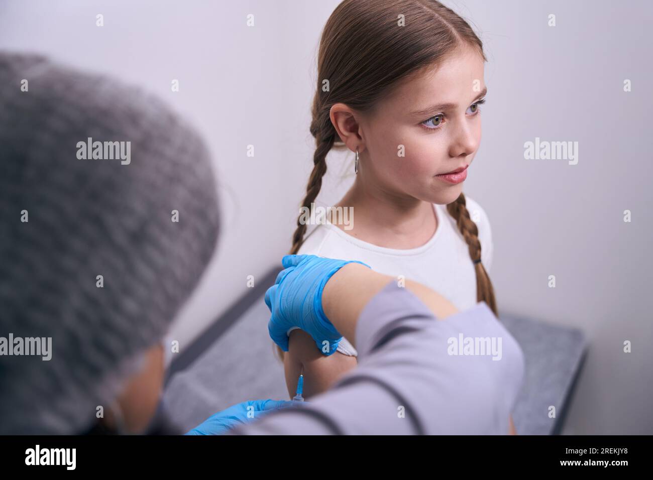 Child in the injection room receives an injection in arm Stock Photo ...