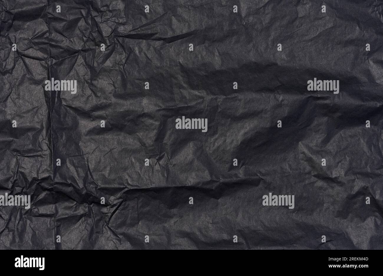 Crumpled sheet of black parchment paper, abstract background Stock ...