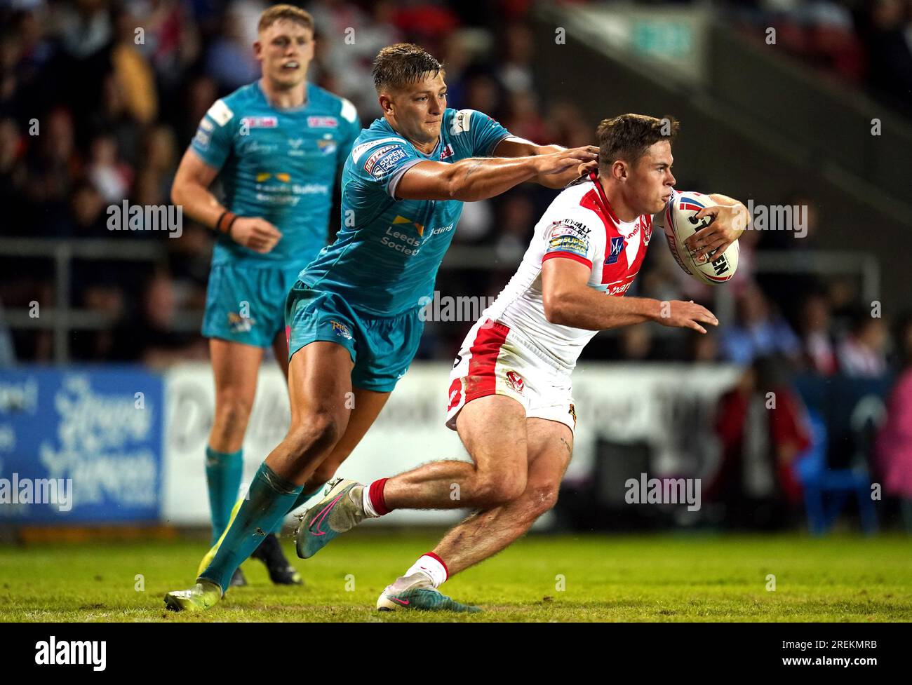 St Helens' Jack Welsby (right) attempts to get past Leeds Rhinos' Sam ...