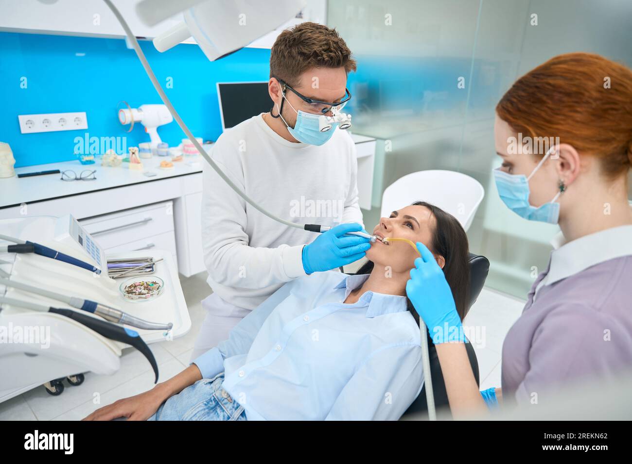 Professional team of stomatologist treating female client teeth Stock ...