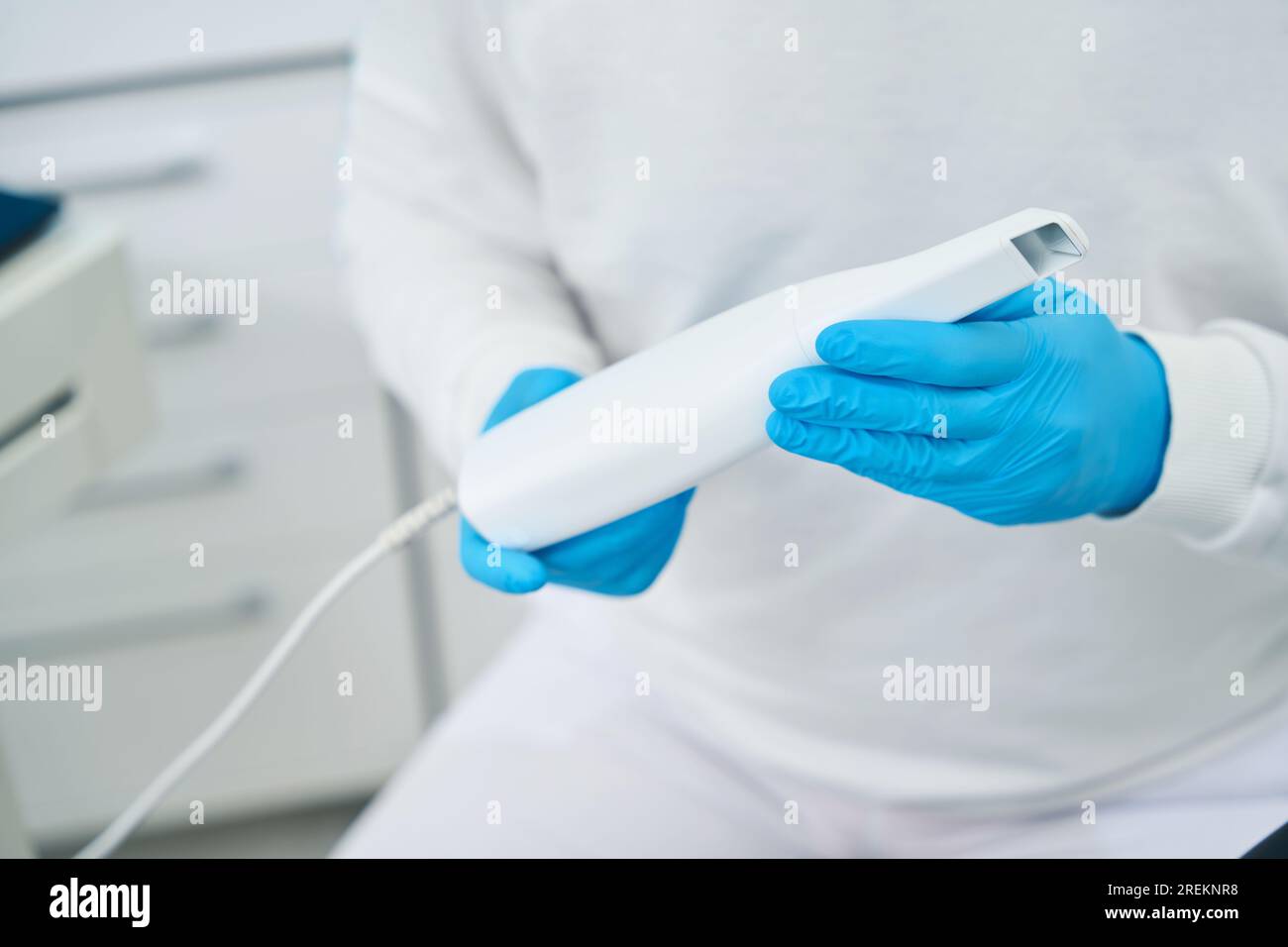 Dental technician holding intraoral camera, that showing to patients ...