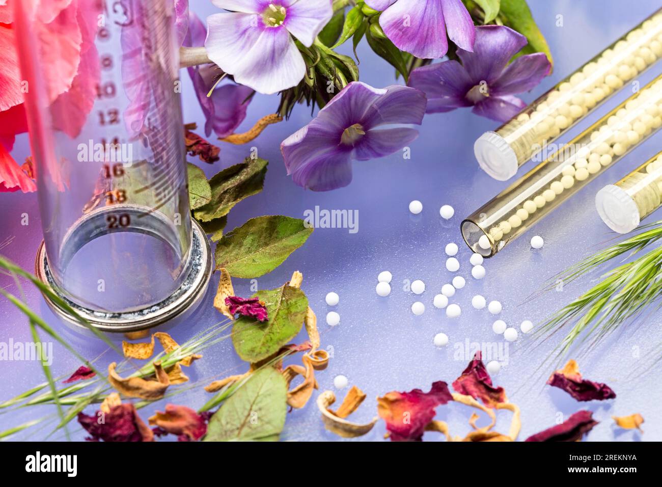 Small glass tubes with homeopathy globules, syringe and flowers Stock ...
