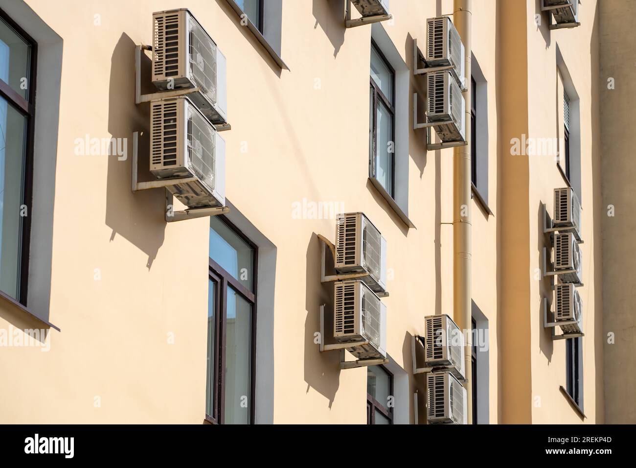Facade of building with many air conditioners on windows in southern ...
