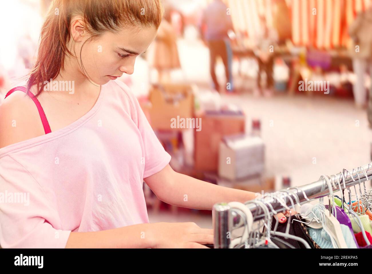 Teenage girl looking for clothes at a flea market Stock Photo - Alamy